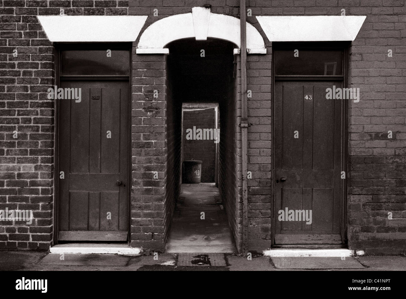 Two front doors with a dustbin at the end of the jennel, Derbyshire ...