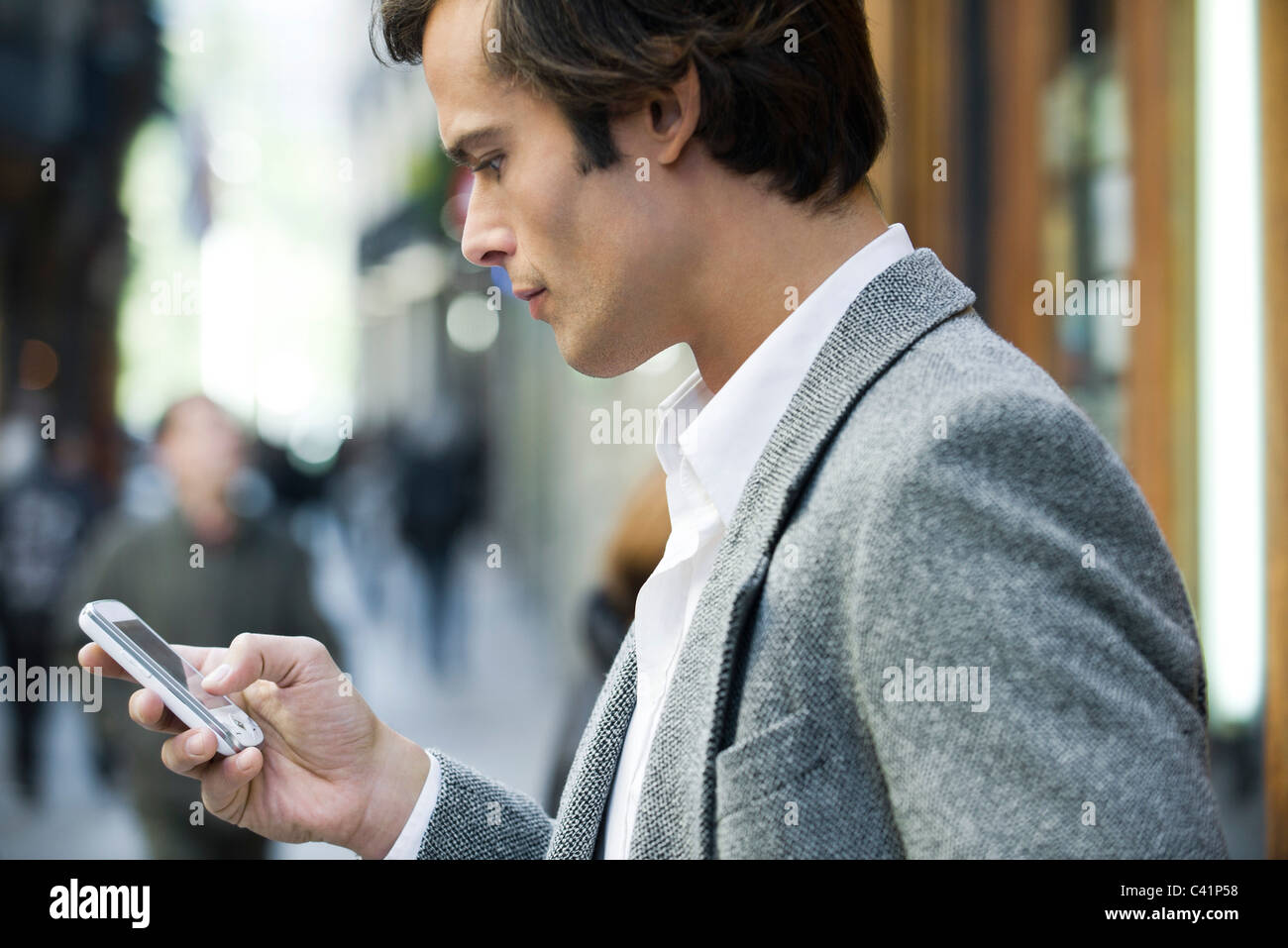Man text messaging outdoors Stock Photo - Alamy