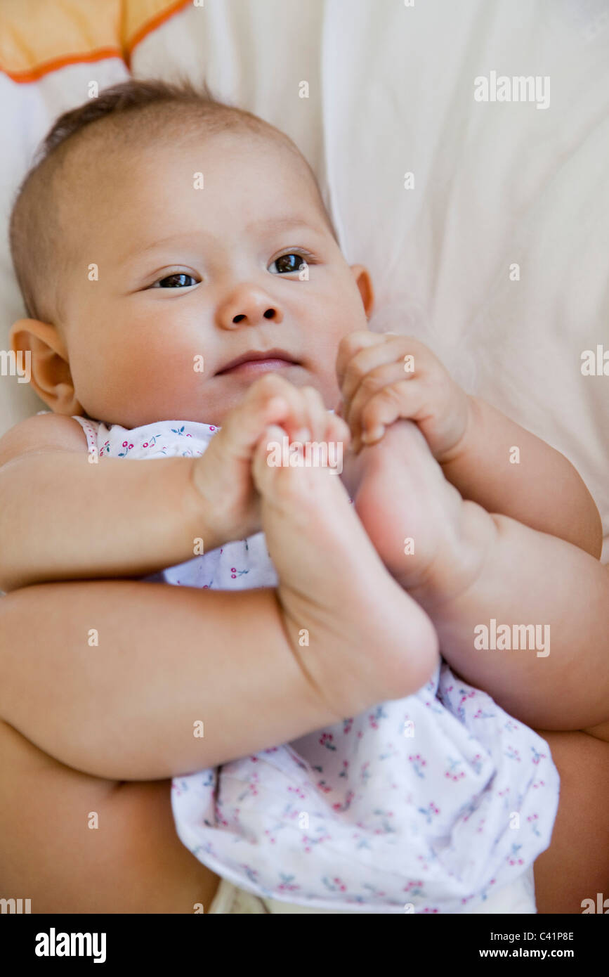 Baby touching feet, portrait Stock Photo - Alamy