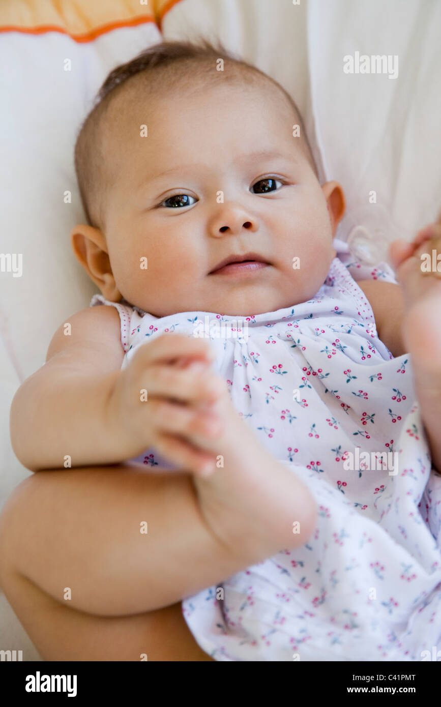Baby touching feet, portrait Stock Photo - Alamy