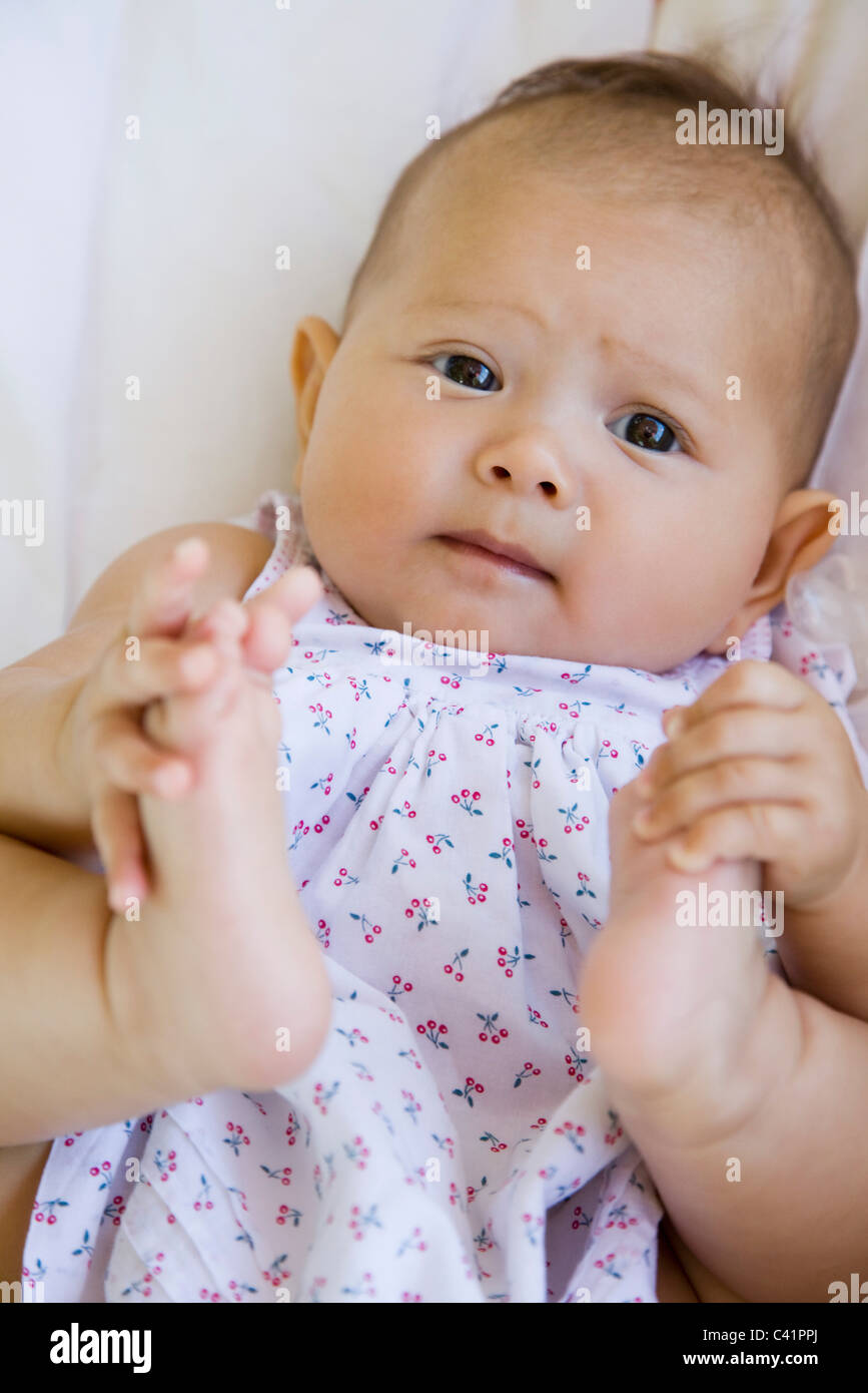 Baby touching feet, portrait Stock Photo - Alamy
