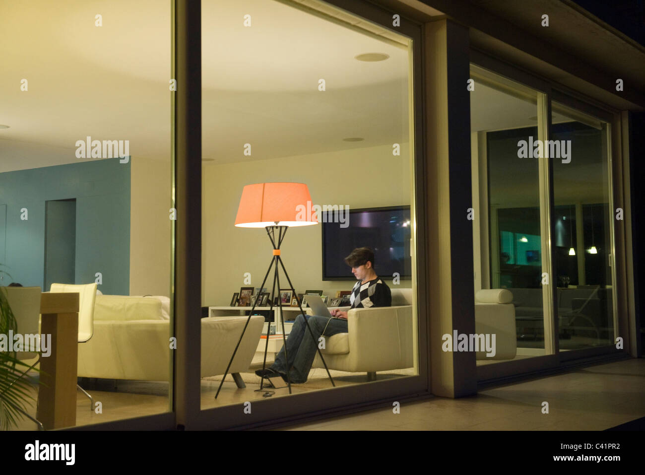 Man outside house night windows hi-res stock photography and images - Alamy