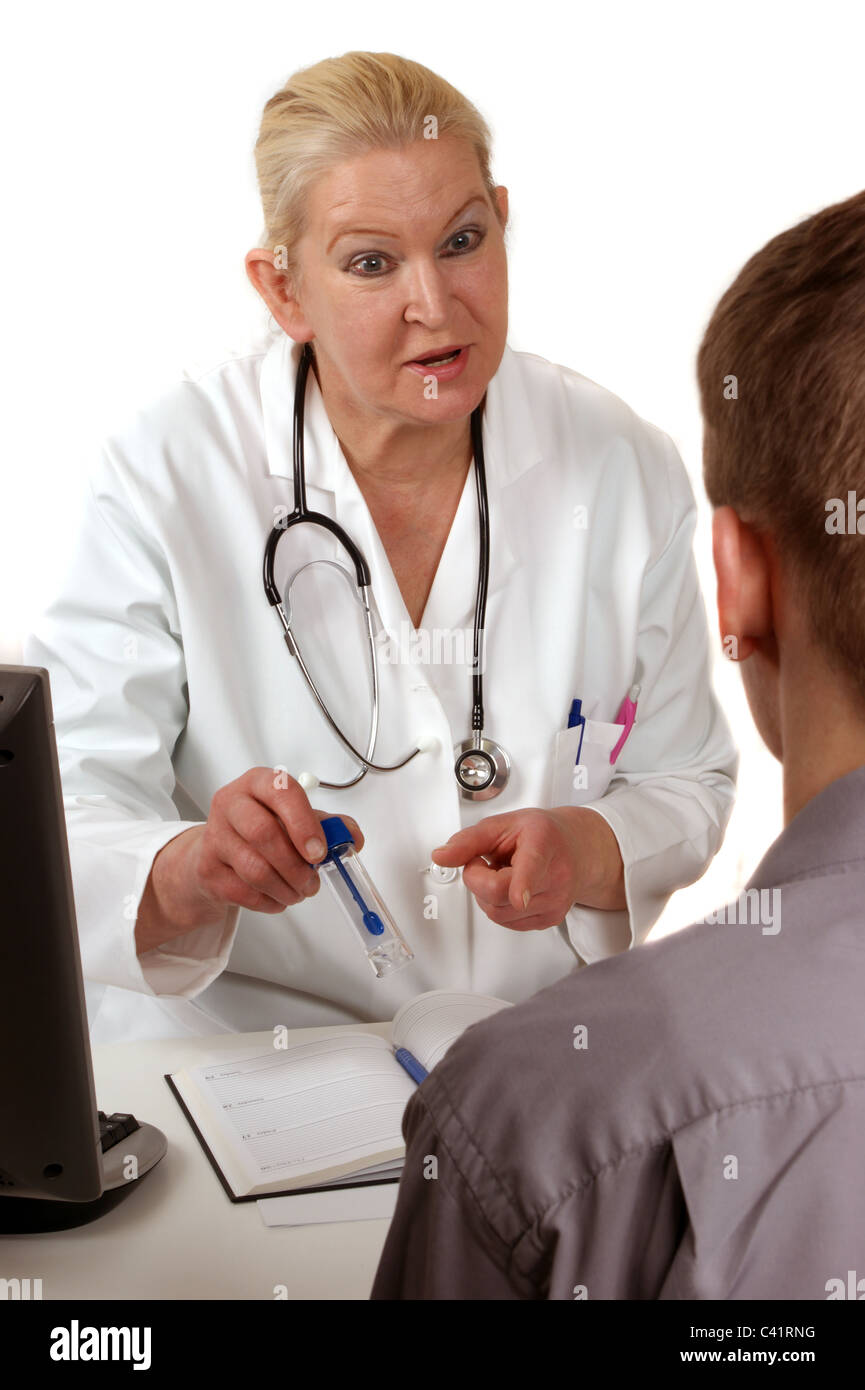 medical assistant shows a patient a stool sample container Stock Photo ...