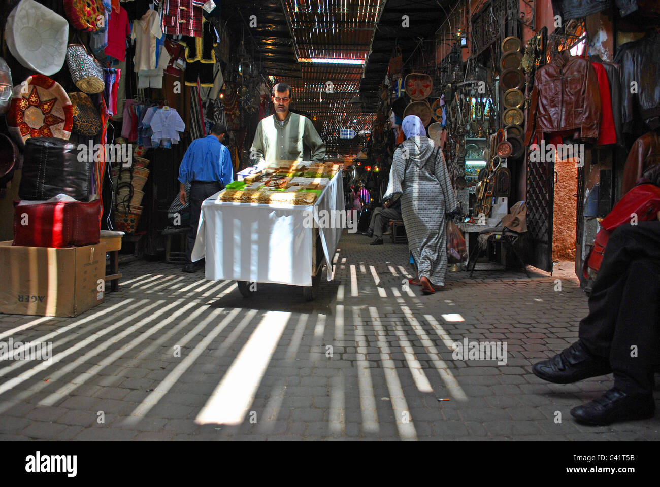 Light streams through slats in the roof of a covered souk in Marrakesh ...