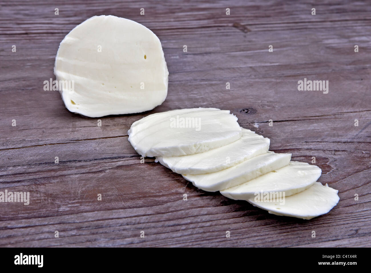 sliced ??mozzarella slices on a wooden board Stock Photo - Alamy