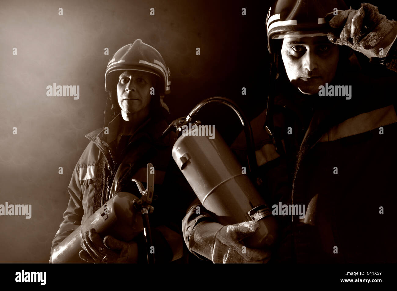 Dramatic image of firemen team in uniform Stock Photo - Alamy