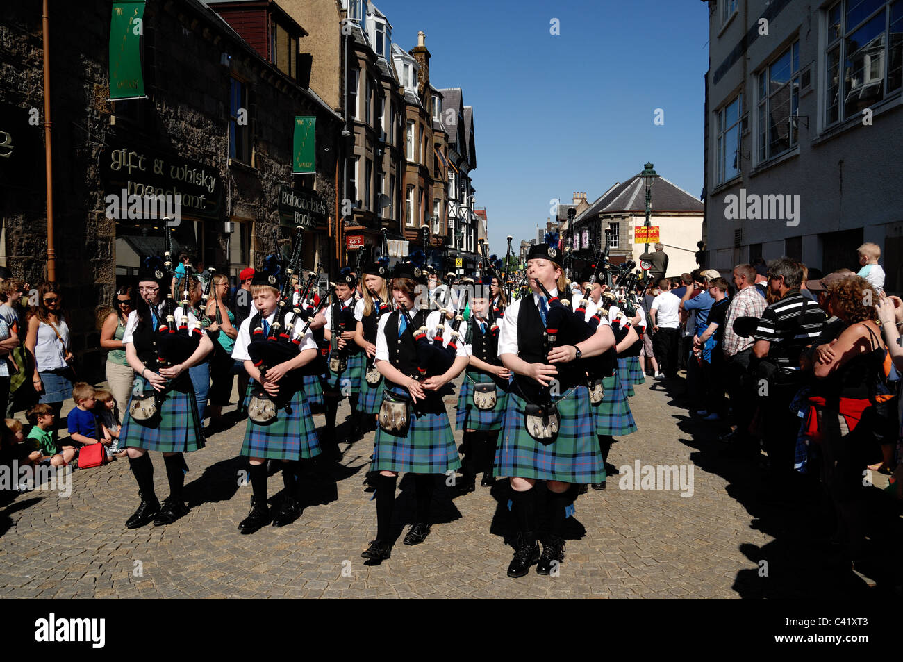 Pipe band leads procession up main high street in front of big crowd in ...