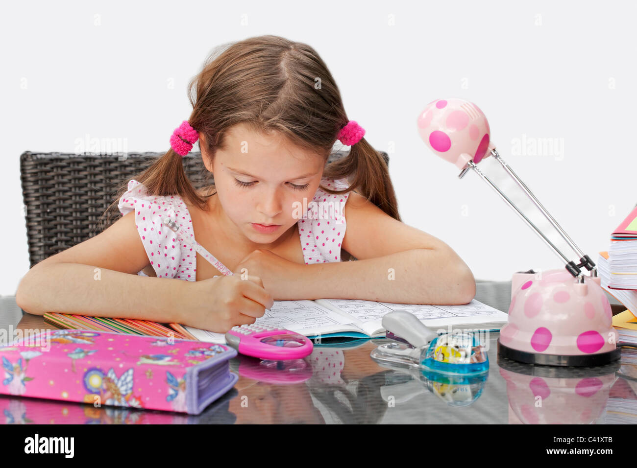 7 year old girl at the table with homework Stock Photo - Alamy