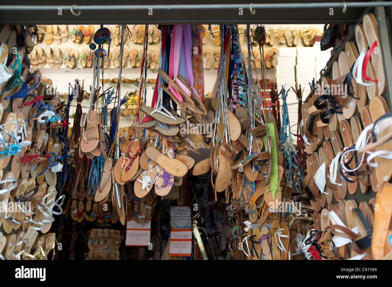 Locally produced sandals hang in a shop entrance in Sorrento, Italy ...
