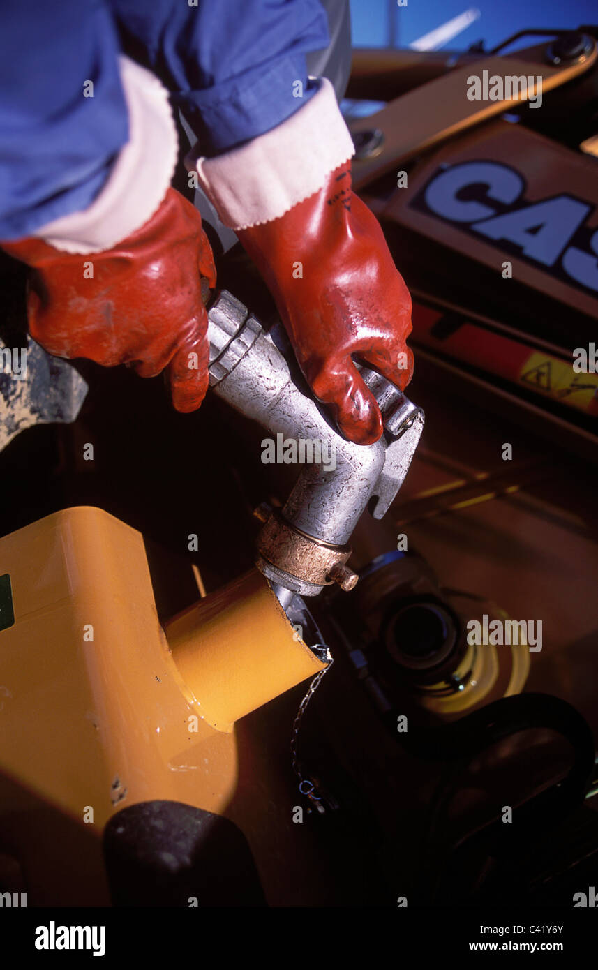 Plant operator filling petrol tank Stock Photo - Alamy