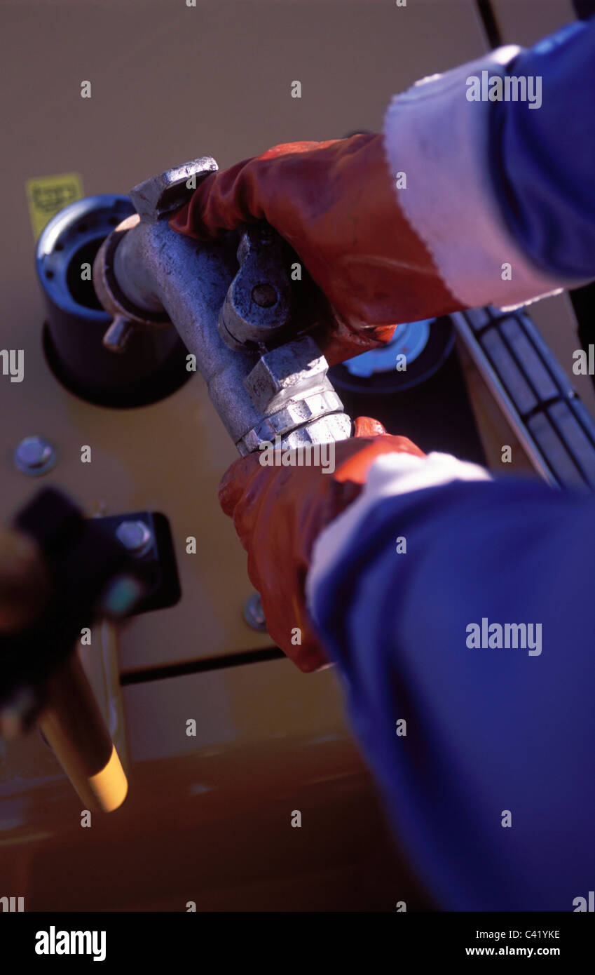 Plant operator filling petrol tank Stock Photo - Alamy