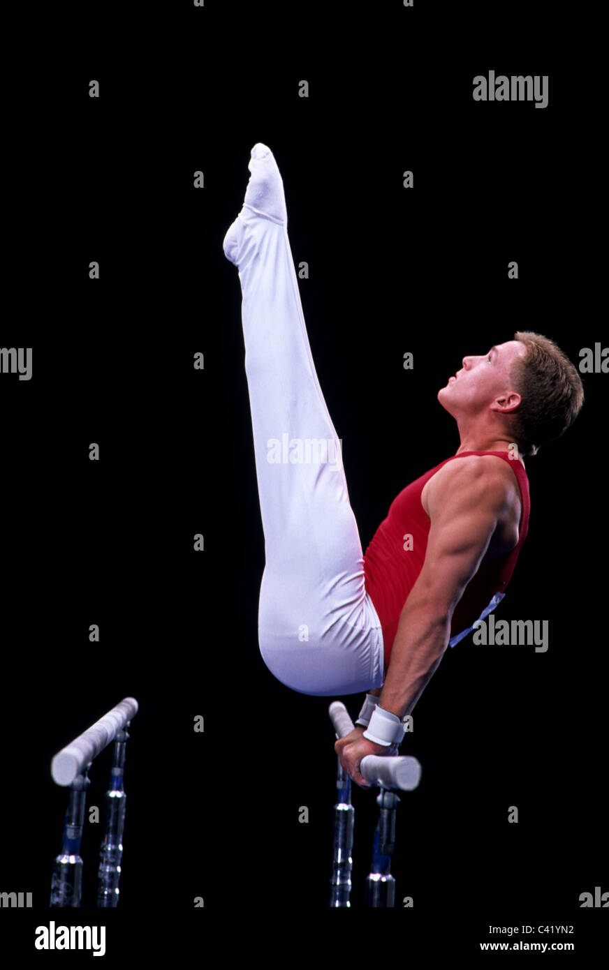 Male gymnast performing on the parallel bars Stock Photo - Alamy