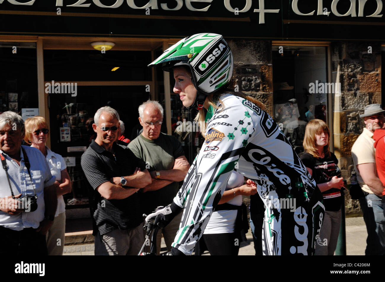 Female motorbike rider in procession of main event in town high street ...
