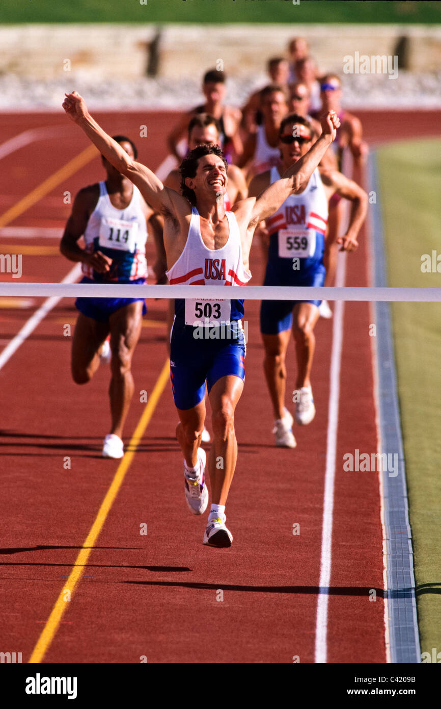Runner celebrates at the finish line Stock Photo - Alamy