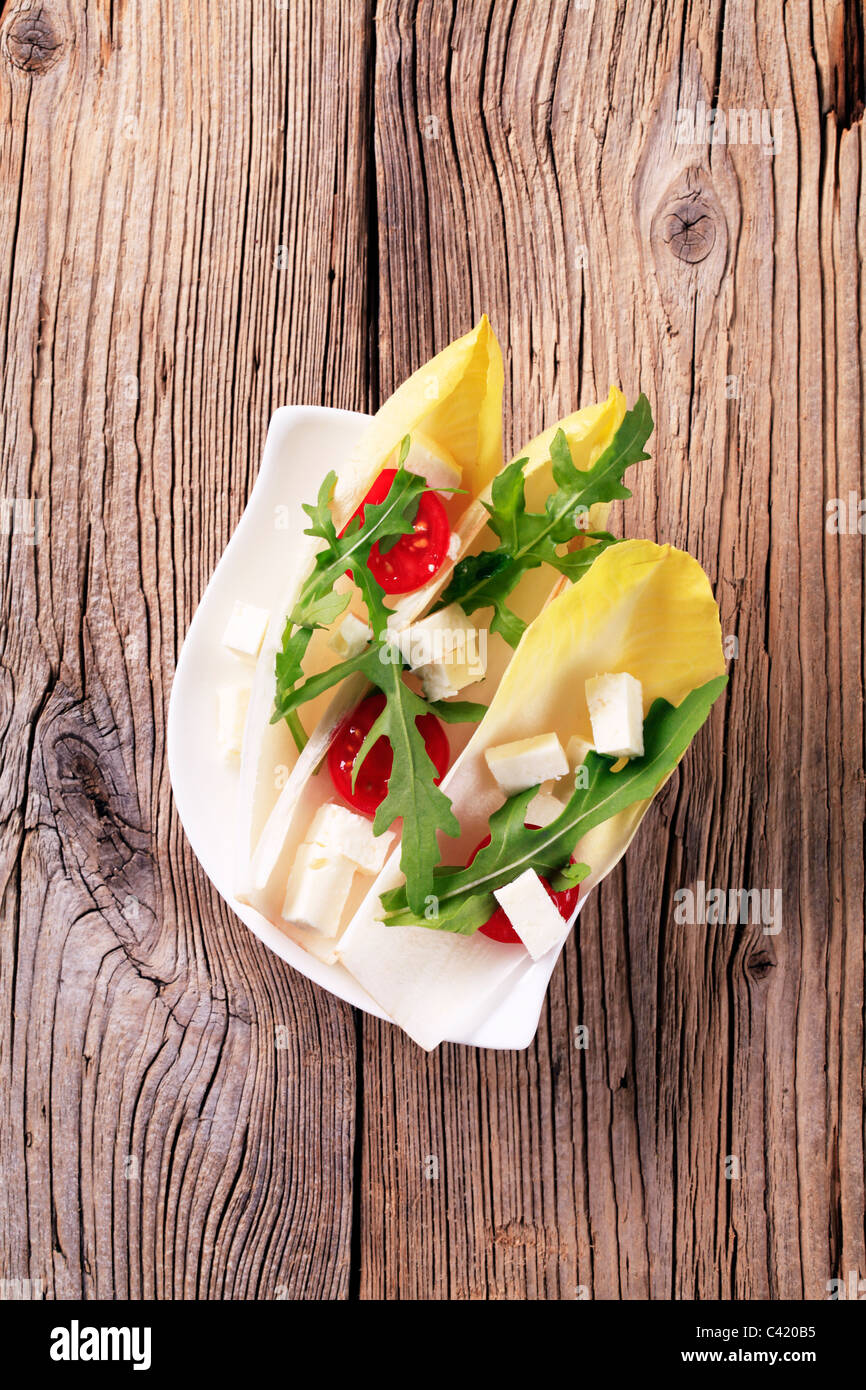 Endive leaves, arugula and diced feta cheese Stock Photo - Alamy