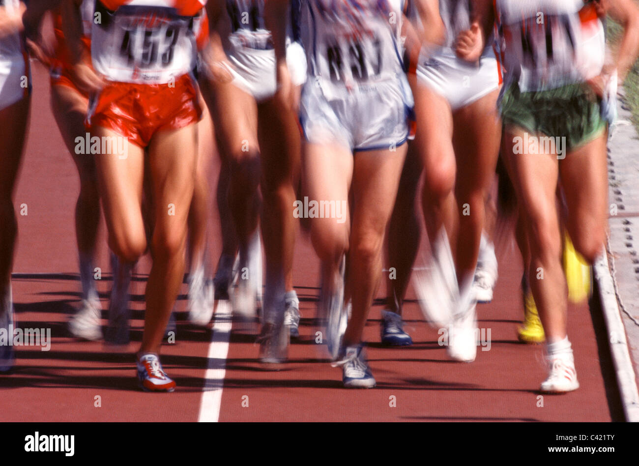 Blurred action of women runners during a track race Stock Photo - Alamy
