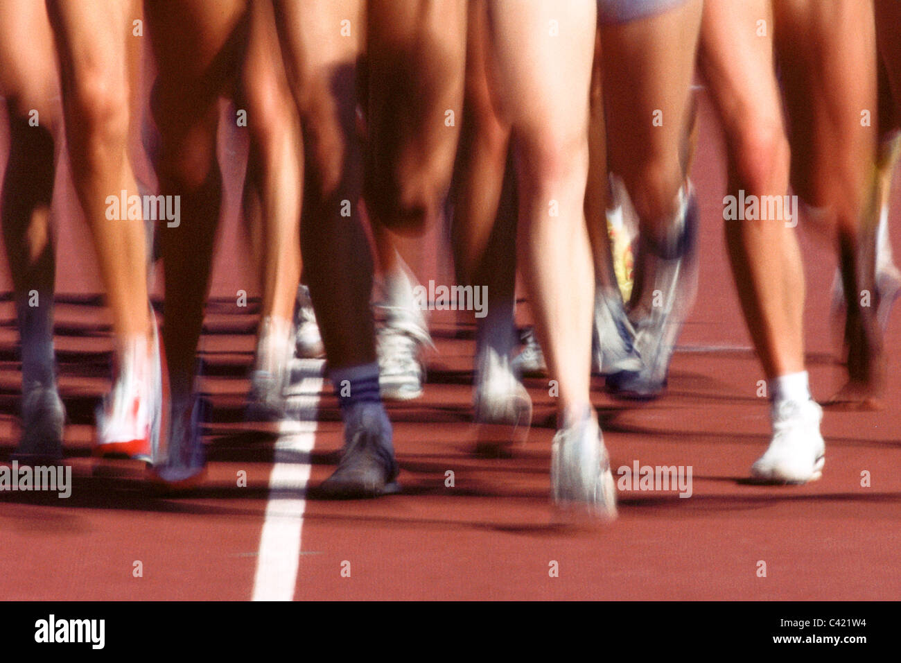 Blurred action of women runners during a track race Stock Photo - Alamy