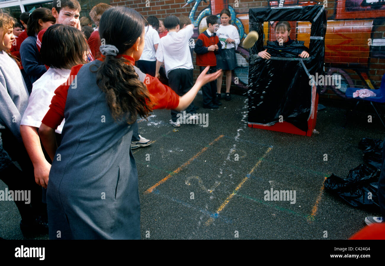 Children Throwing Wet Sponges For Comic Relief In School Playground ...