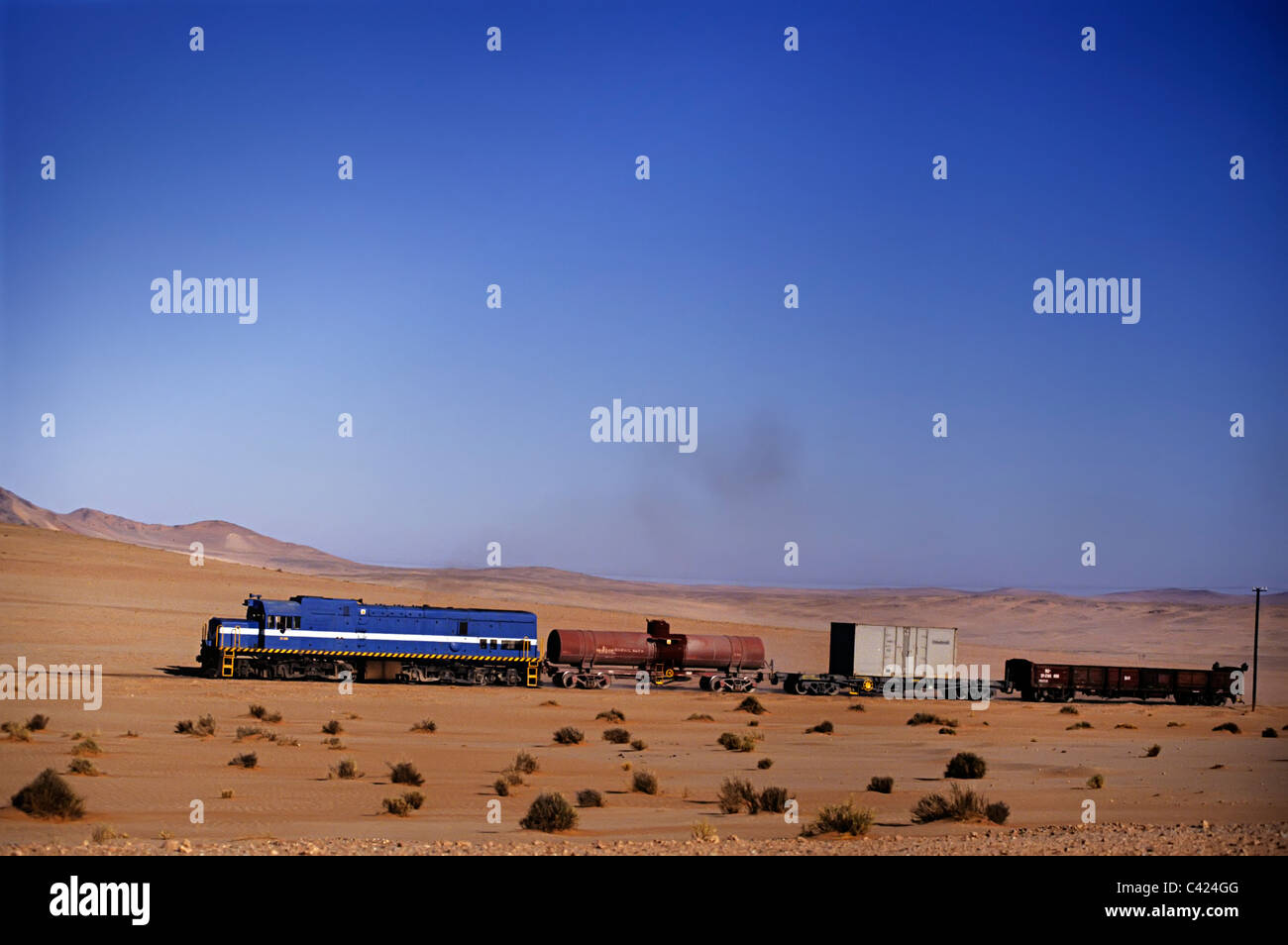 Diesel locomotive pulling freight across the Namib desert ,Namibia ...