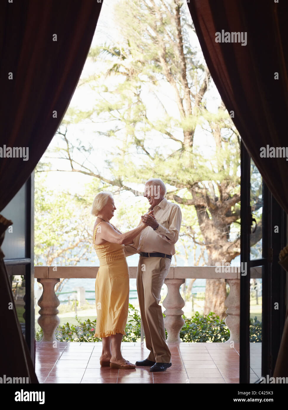 senior caucasian couple on vacation, dancing on terrace in hotel ...