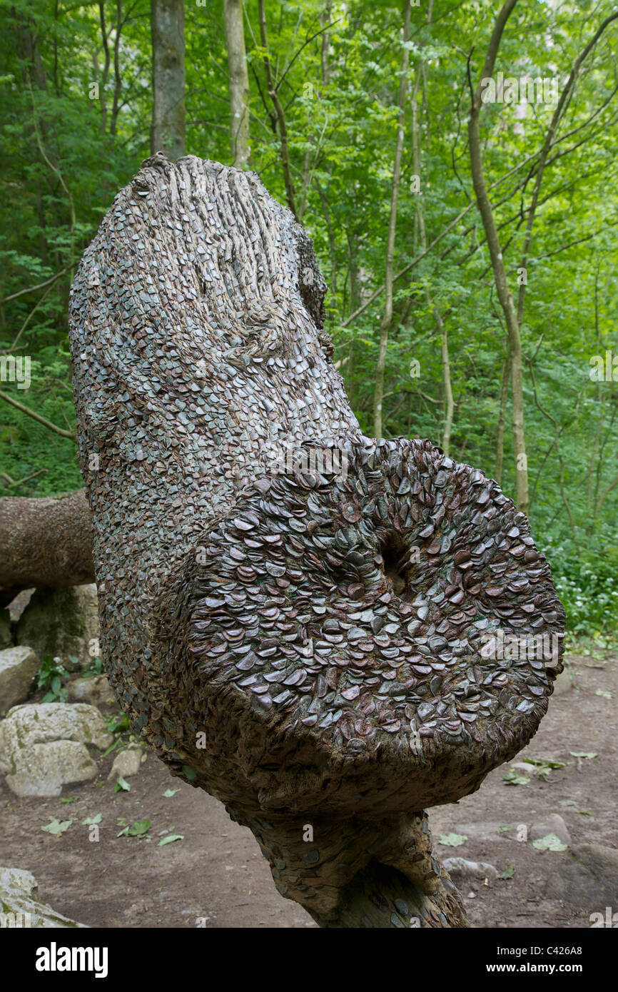 "money tree" with copper and silver coins hammered into the wood, near ...
