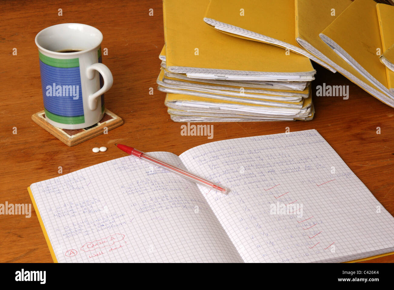Teacher Marking Books Stock Photo - Alamy