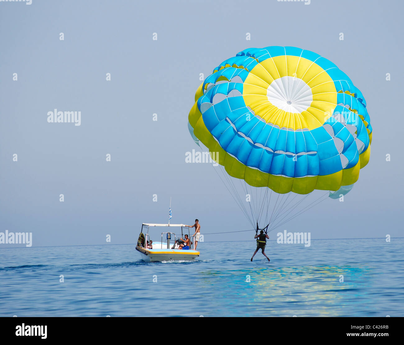 Paraglider airborne being towed by a boat at sea Stock Photo - Alamy