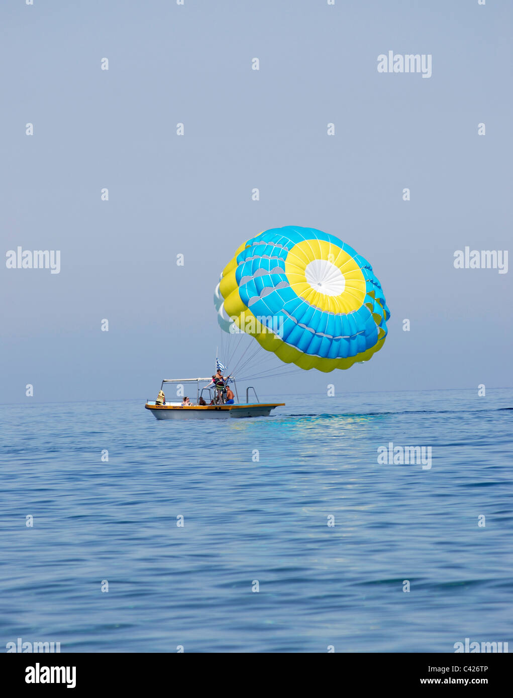 Paraglider airborne being towed by a boat at sea Stock Photo - Alamy