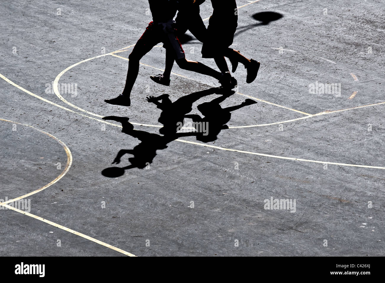 Shadows cast by basketball players Stock Photo - Alamy