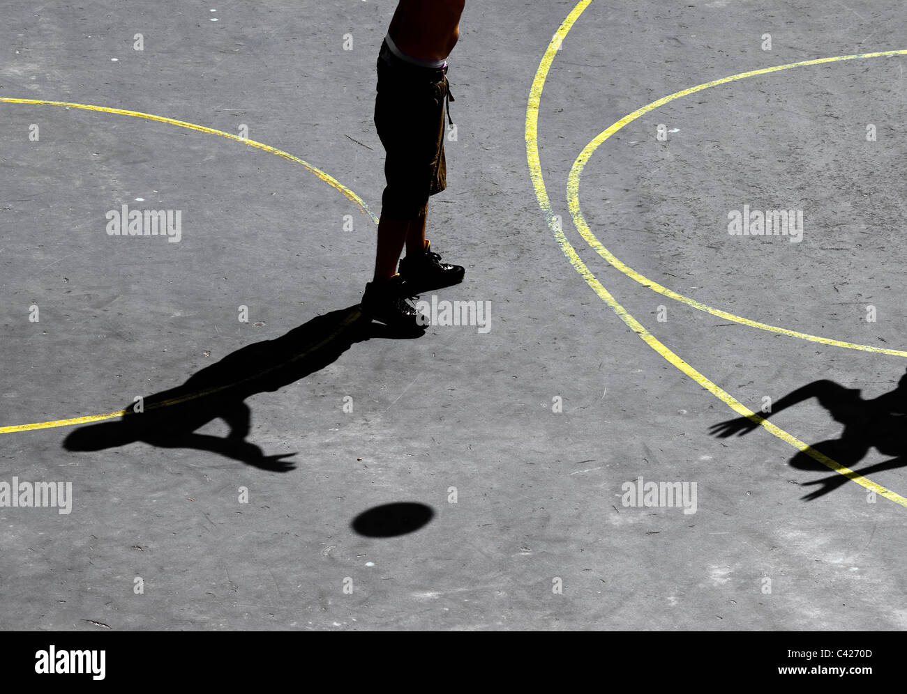 Shadows cast by basketball players Stock Photo - Alamy