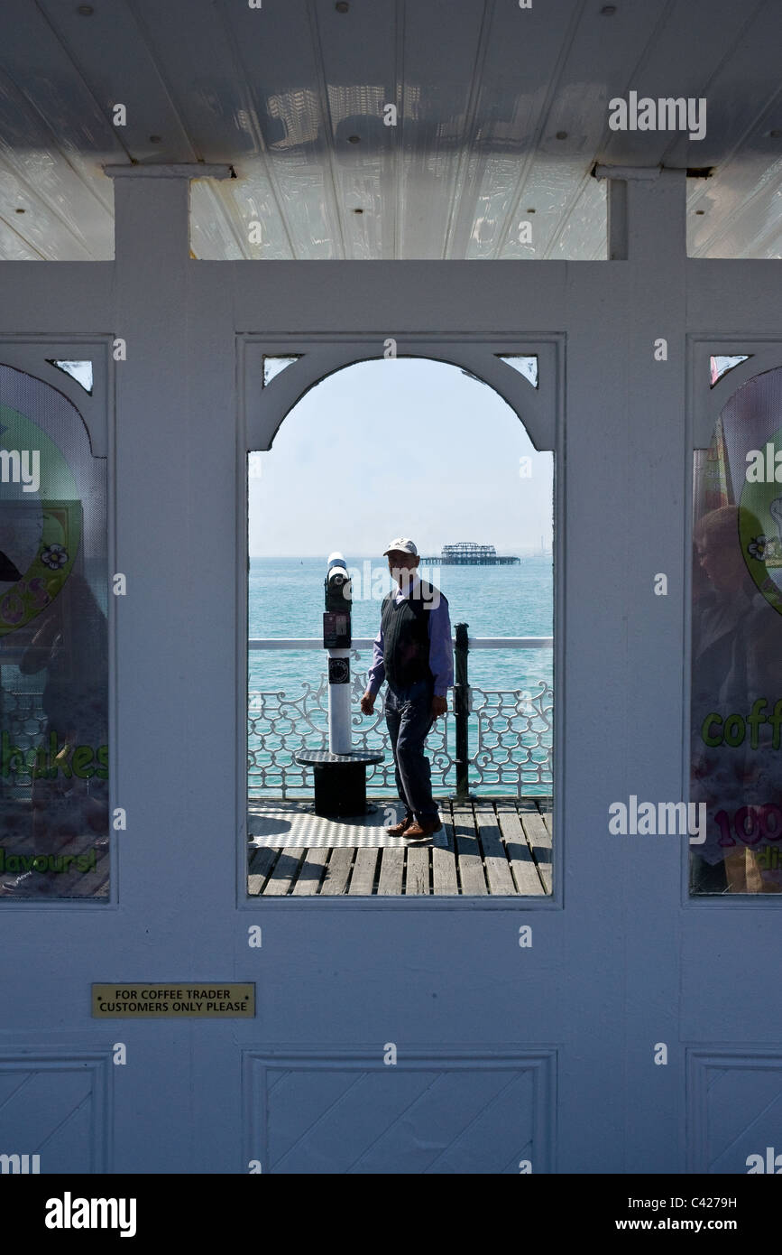 A man seen through a window on Brighton Pier. Photo by Gordon Scammell ...