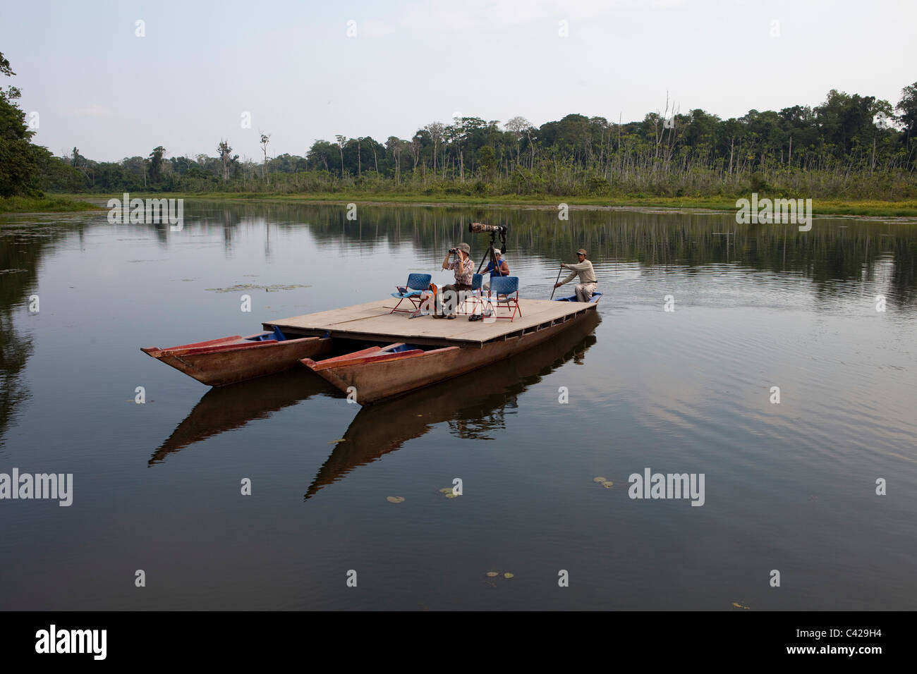 Peru, Boca Manu, Manu National Park, Tourist and boatsmen with ...