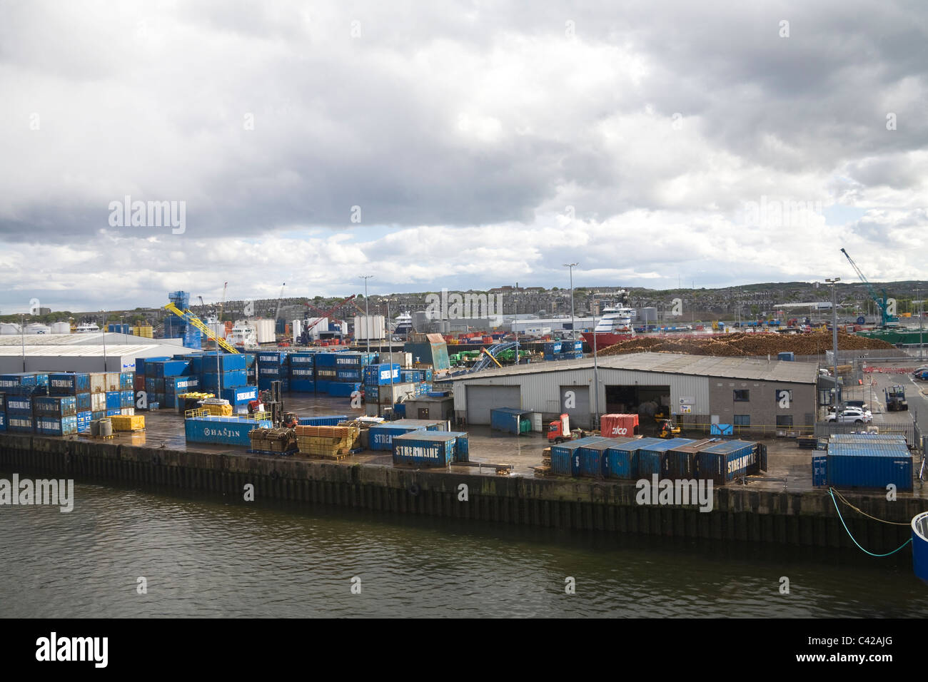 Aberdeen Scotland Piles of timber and shipping containers line the dock ...