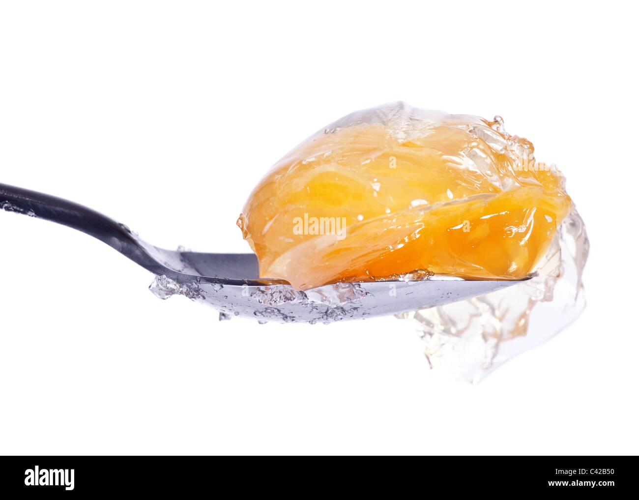 mandarin in jelly on spoon, white background Stock Photo - Alamy