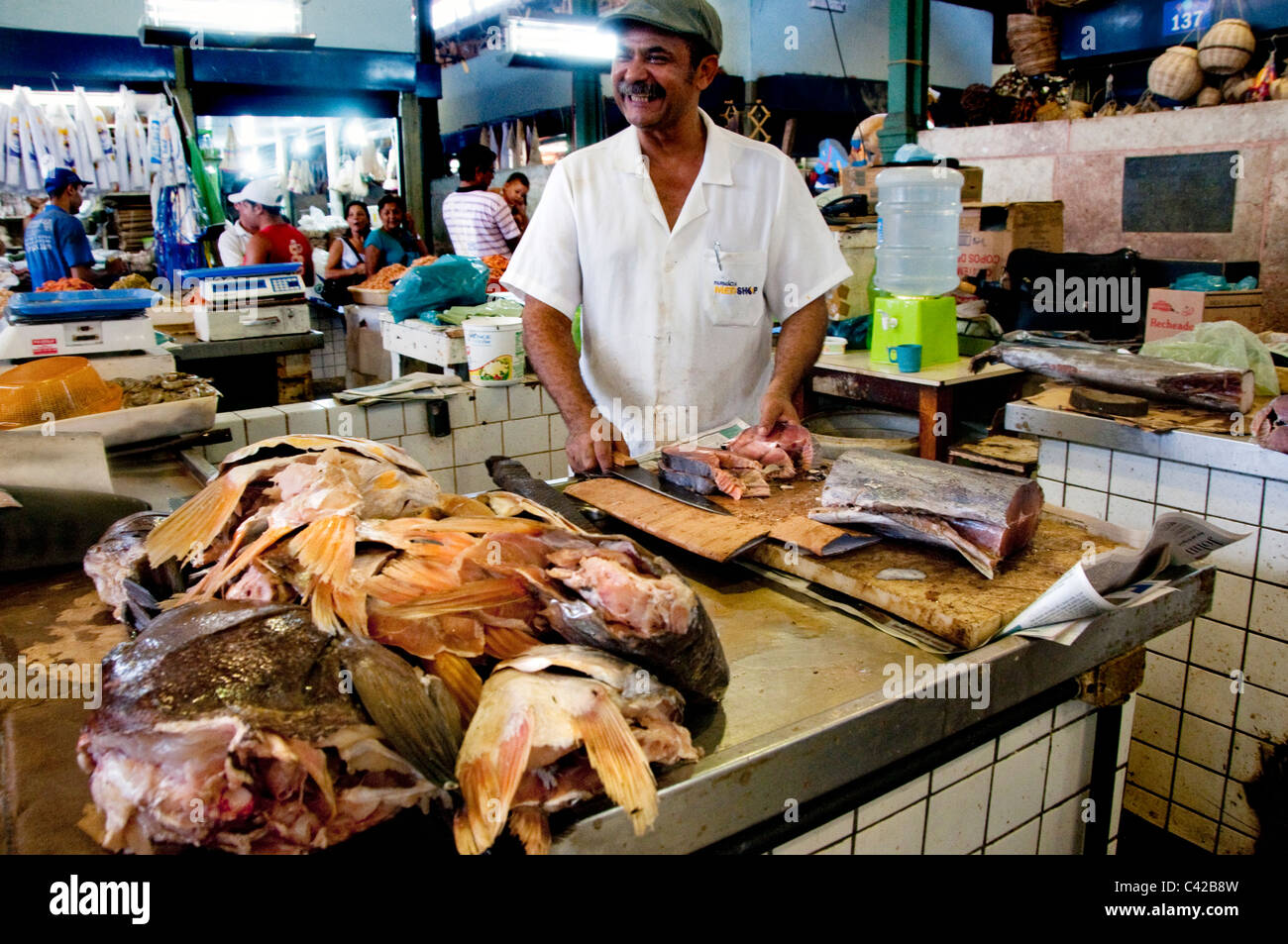 Fish monger cutting up fish in stall in market in Recife Brazil Stock ...