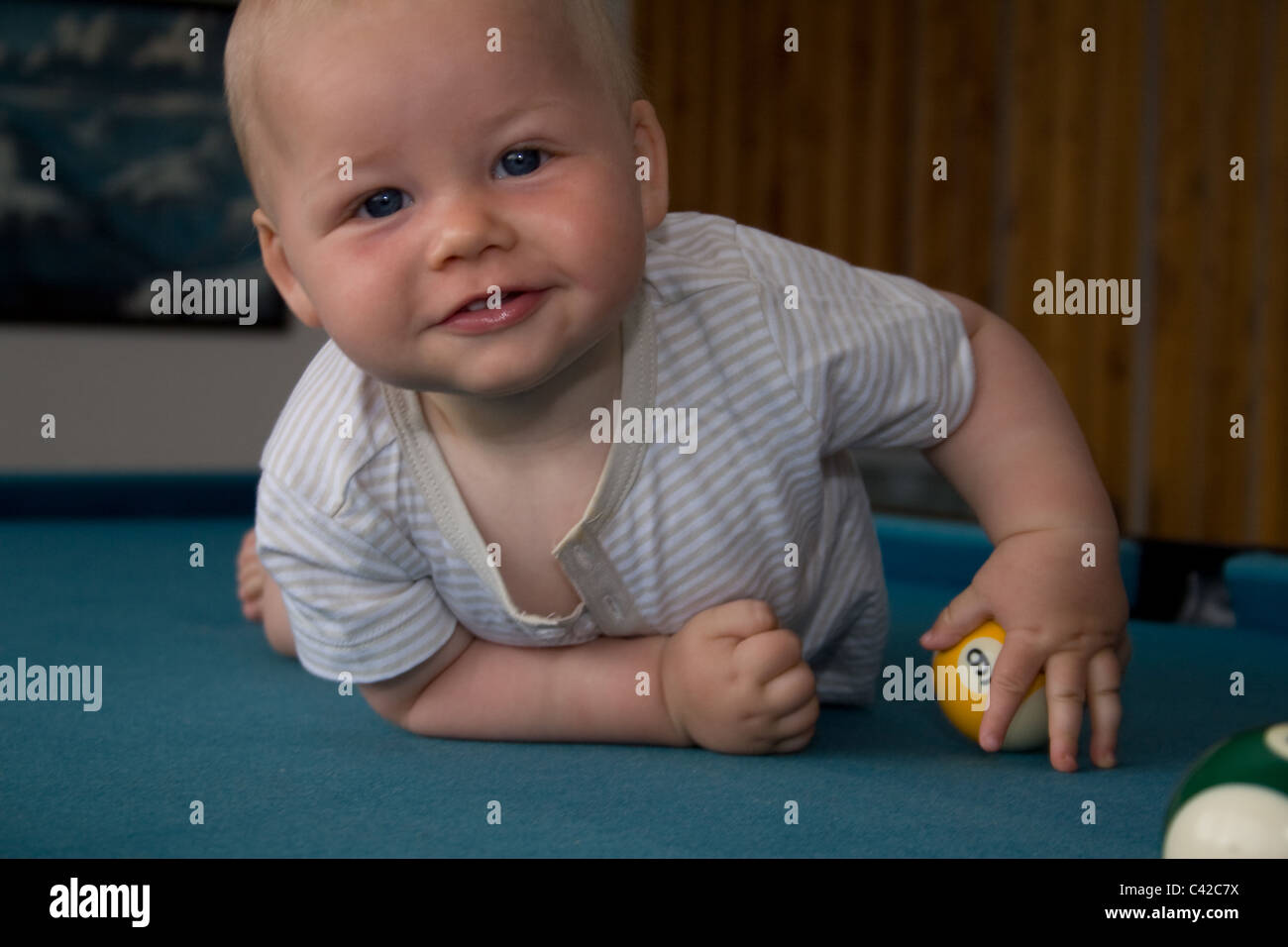 Baby playing on a pool table Stock Photo - Alamy