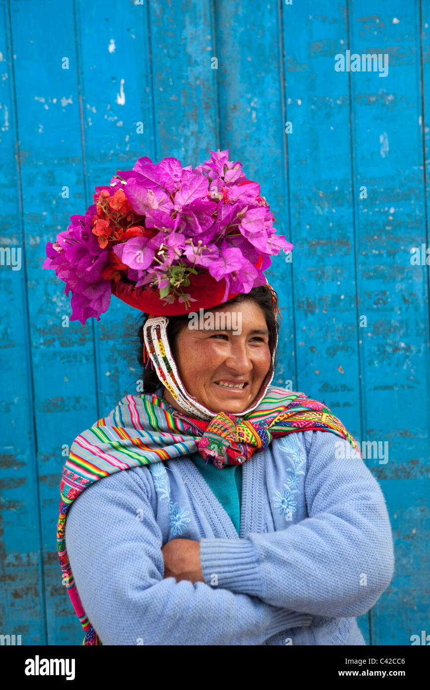 Peru, Ollantaytambo, Indian woman with flowers in hat, an Indian custom ...