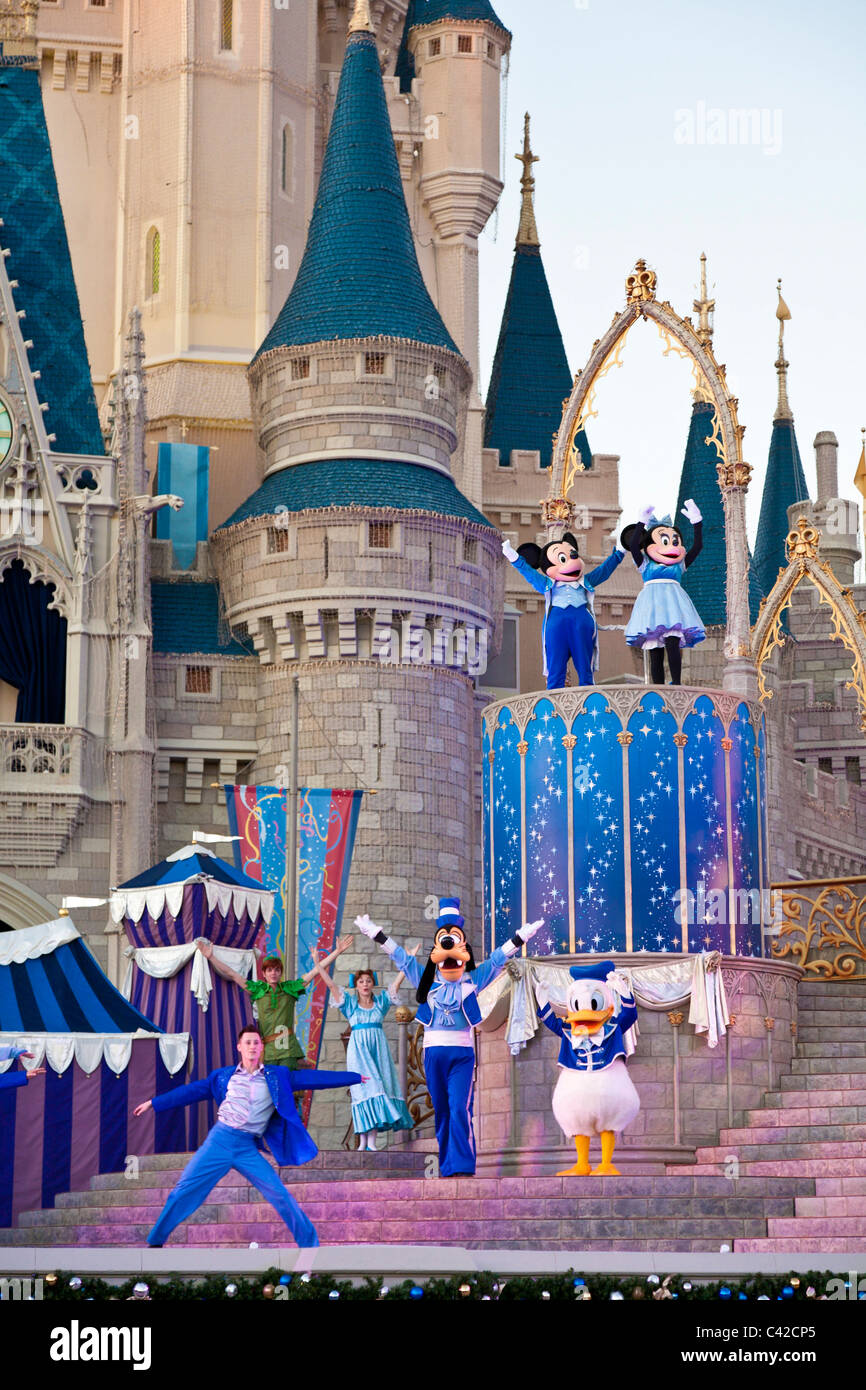 Show at Cinderella's castle features many Disney characters in costume ...
