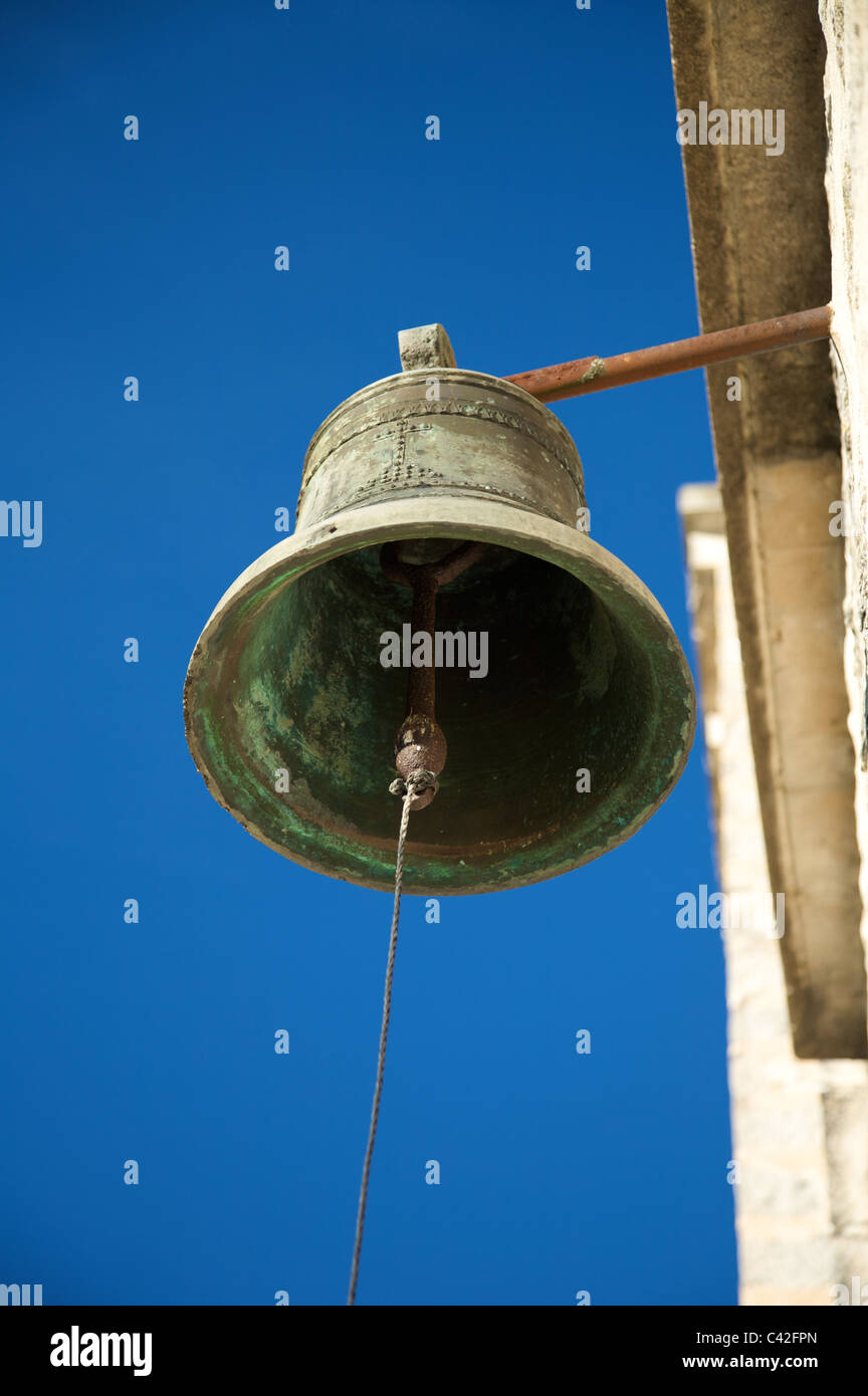 old green bell on a stone wall Stock Photo - Alamy