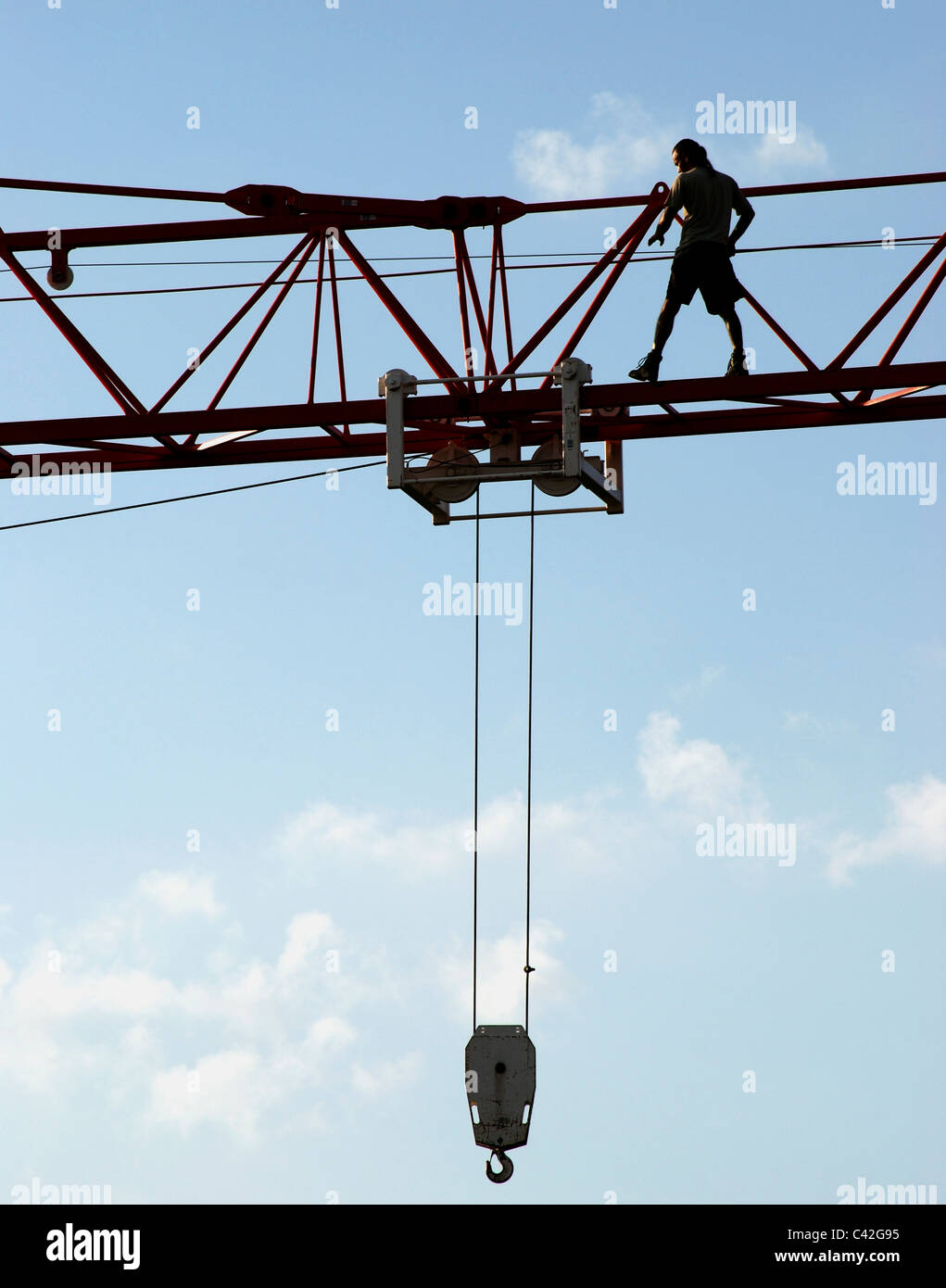 Man working on, repairing, maintaining a crane Stock Photo - Alamy
