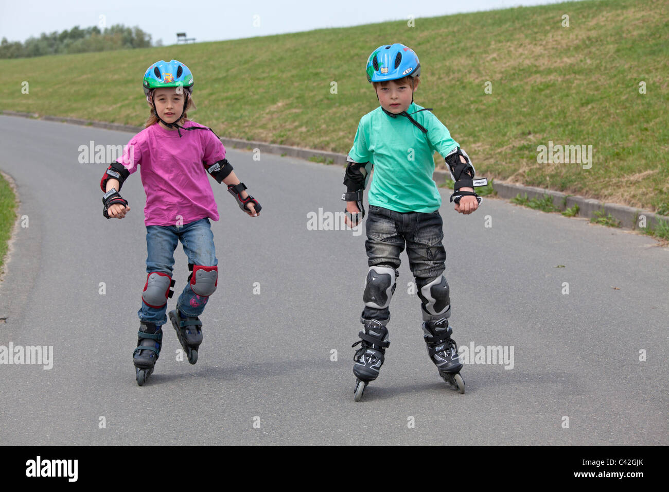 young brother and sister in-line skating together Stock Photo - Alamy