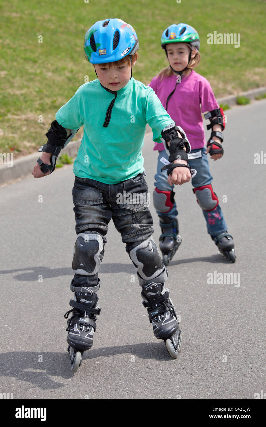 young brother and sister in-line skating together Stock Photo - Alamy