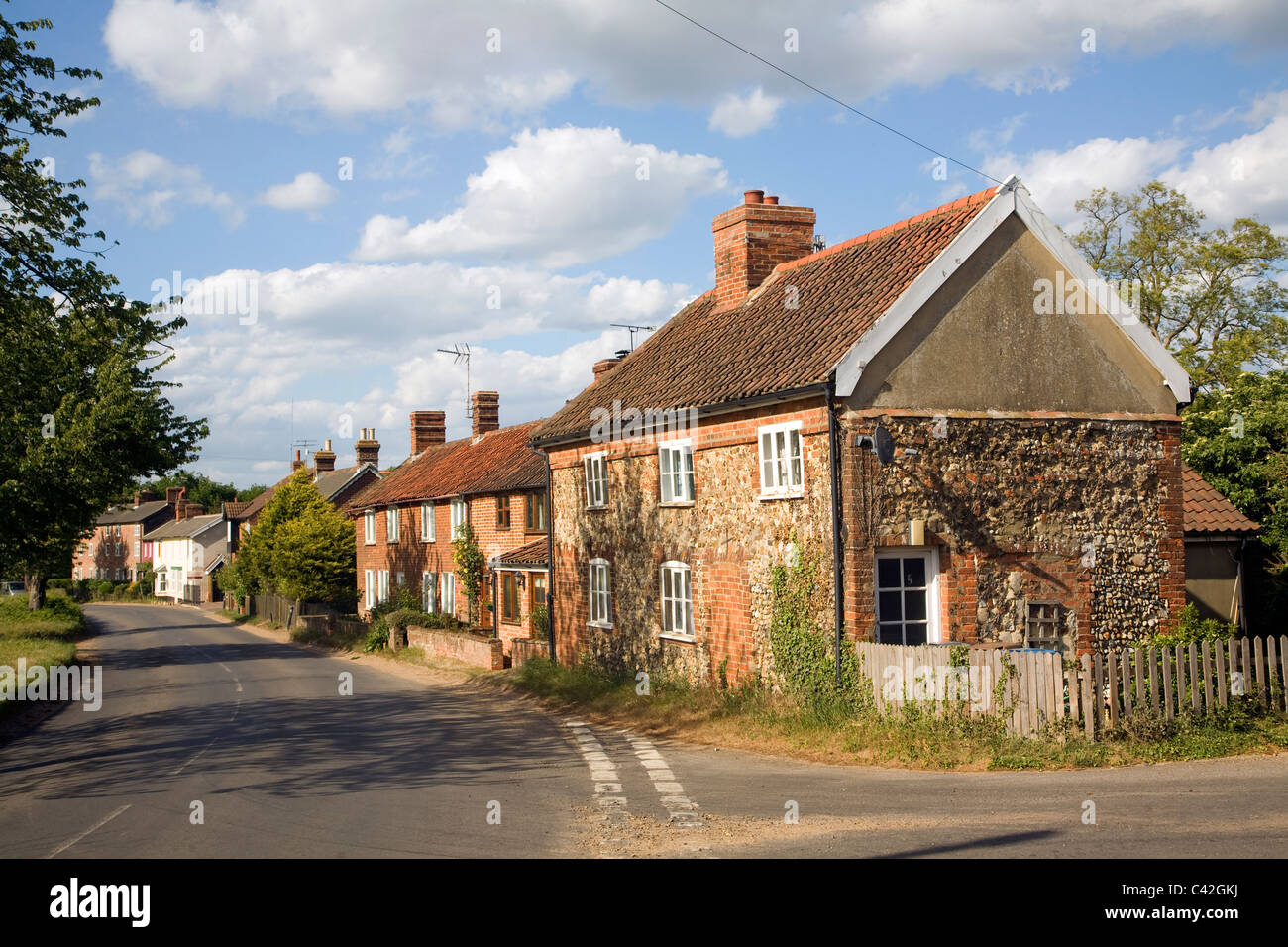 Traditional cottages line the street of the village of Butley, Suffolk ...