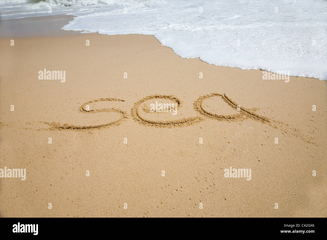 Sea written in sand Stock Photo - Alamy