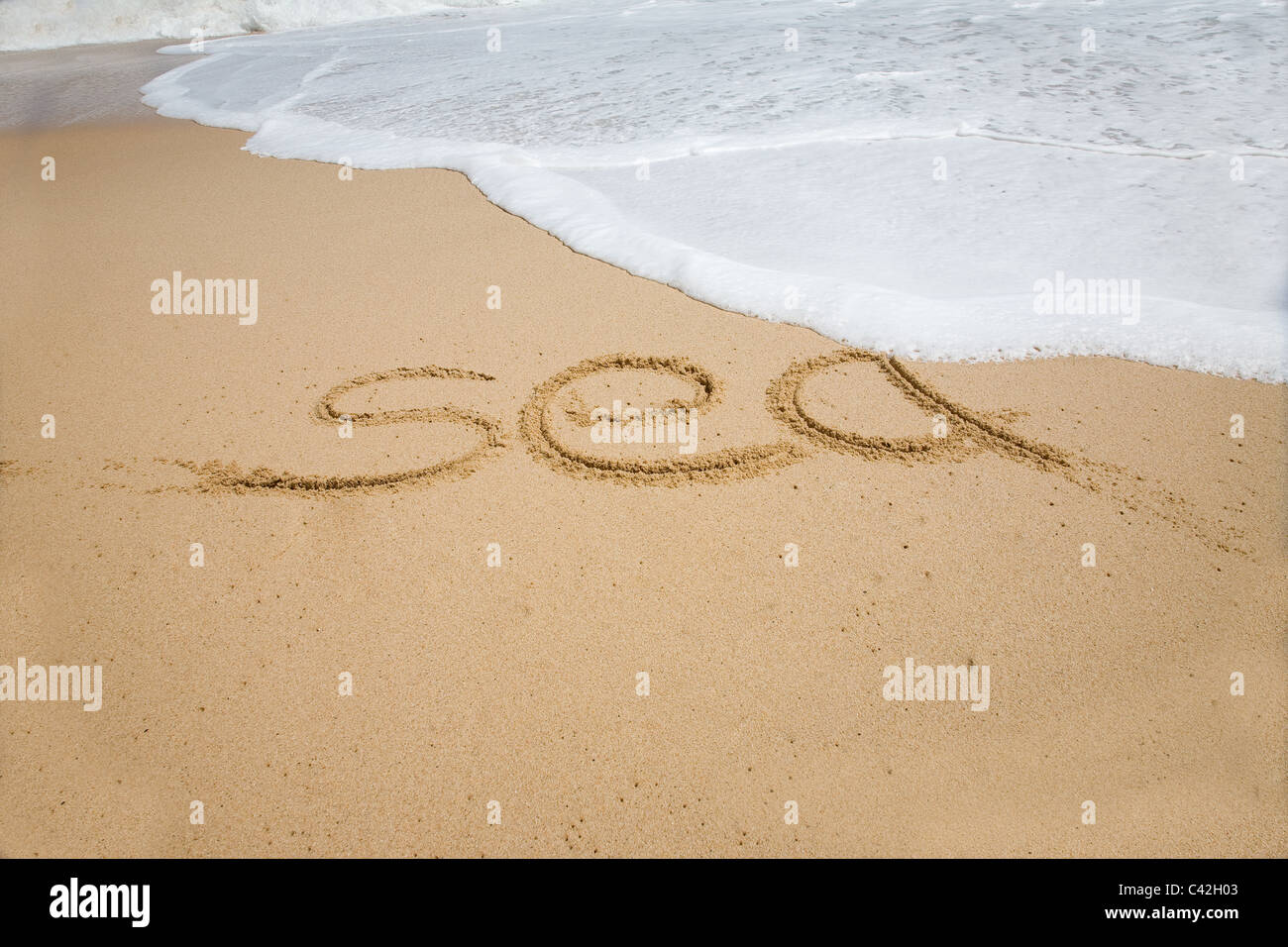Sea written in sand Stock Photo - Alamy