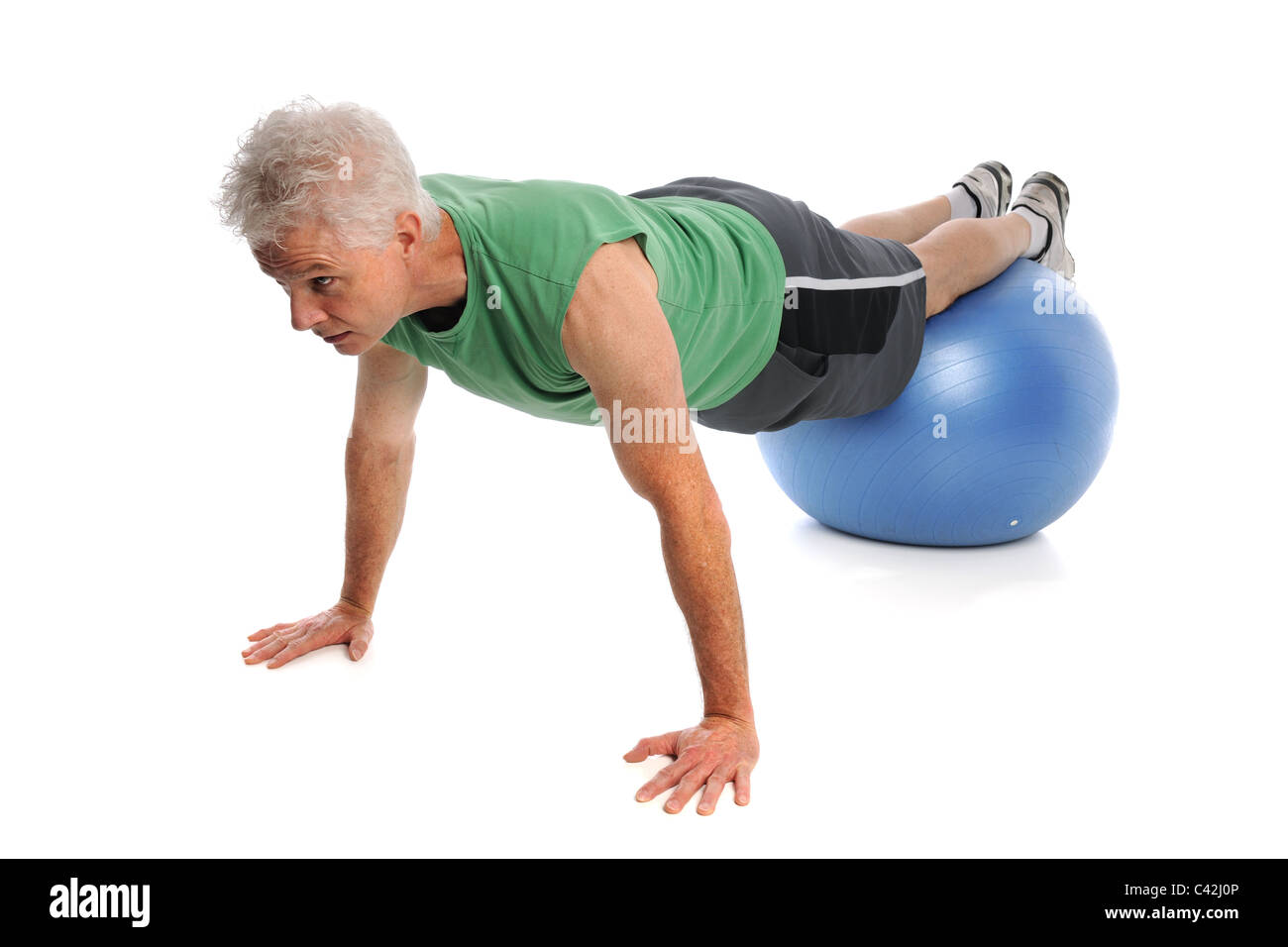 Mature man using fitness ball isolated over white background Stock ...