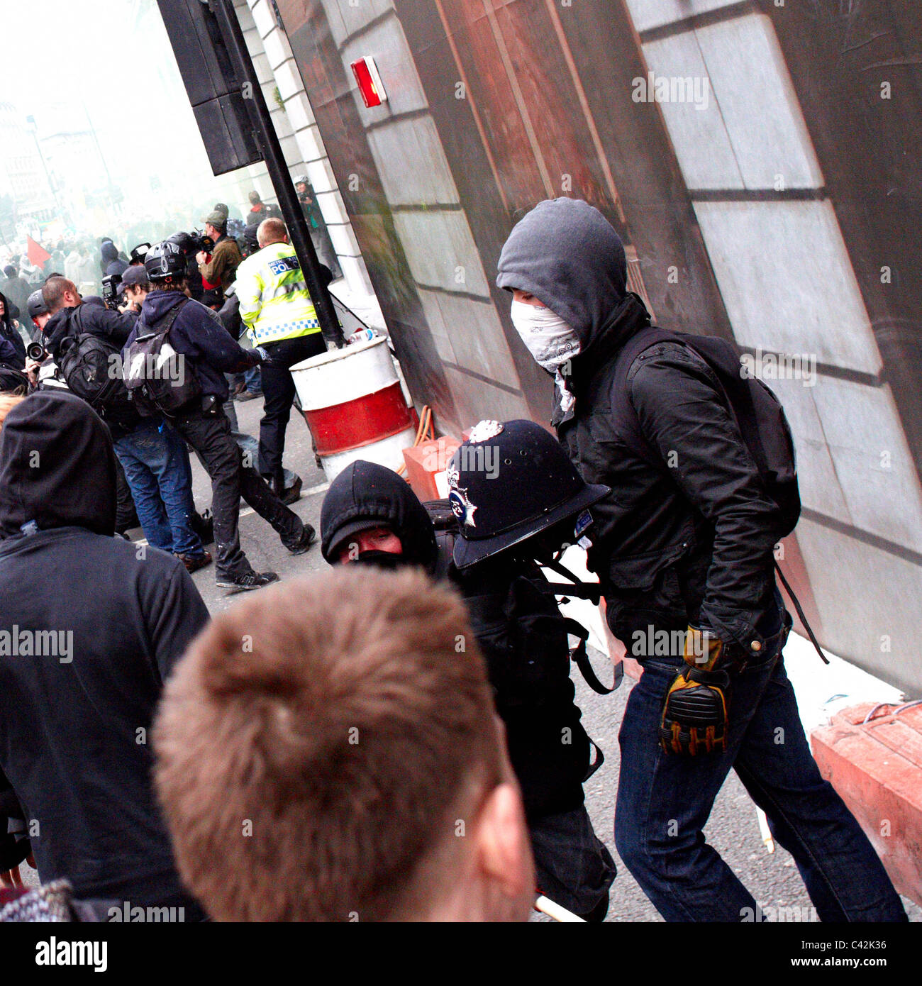 Masked youth with a police helmet during disorder at the March to the ...