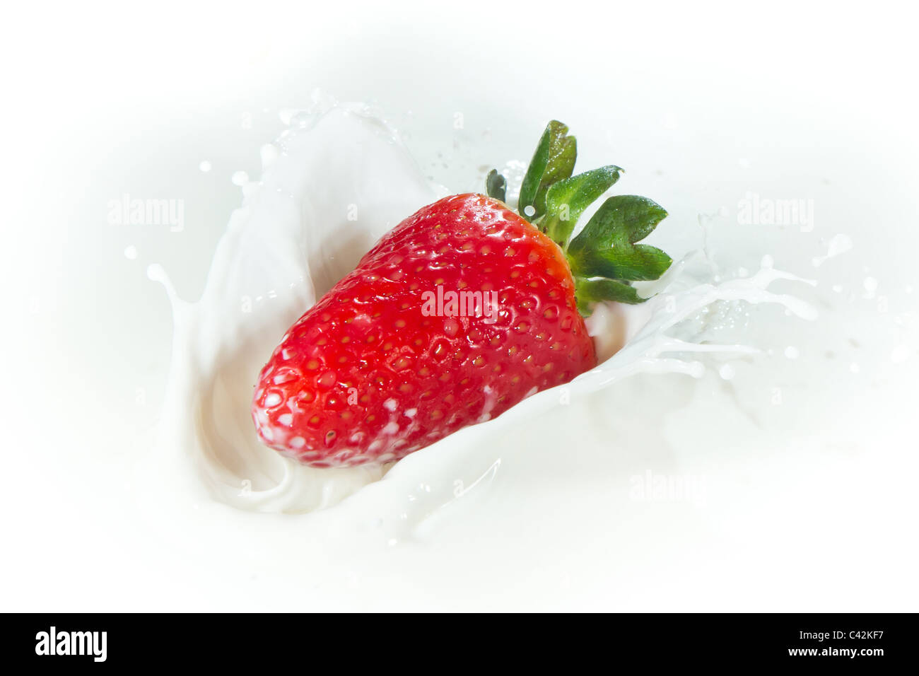 Strawberry falling into milk hi-res stock photography and images - Alamy