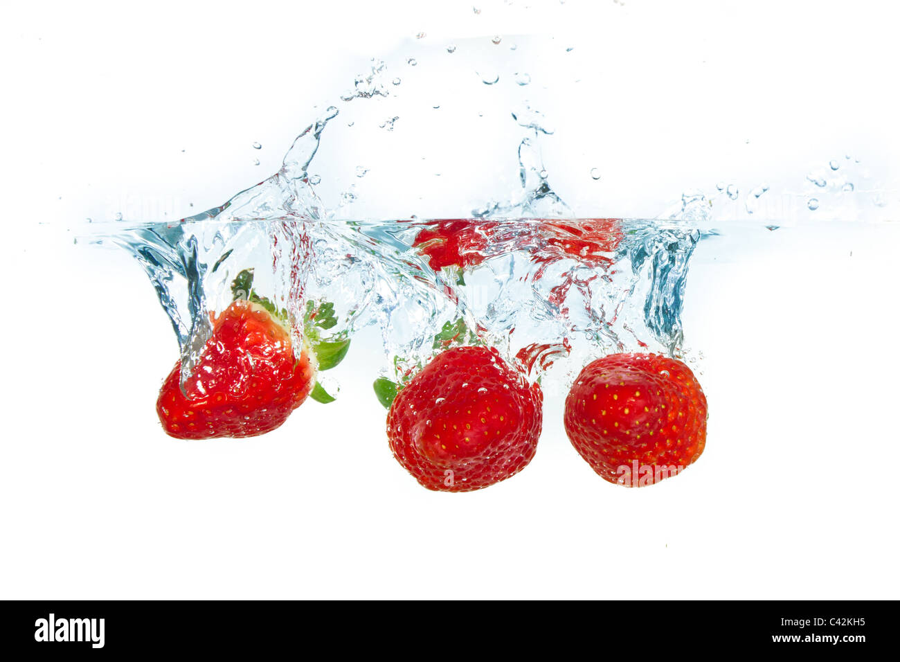 Strawberry splash on white background hi-res stock photography and ...