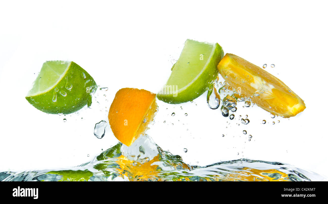 citrus fruit splashing isolated on white background Stock Photo - Alamy